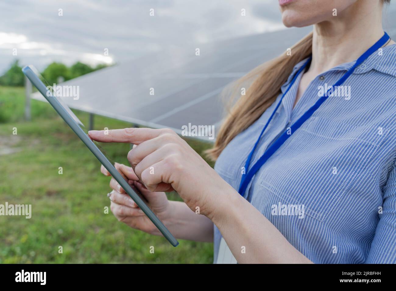 Engineer using tablet PC at solar station Stock Photo - Alamy
