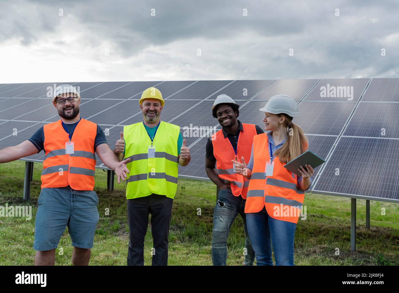 Happy engineers standing together at solar power station Stock Photo ...