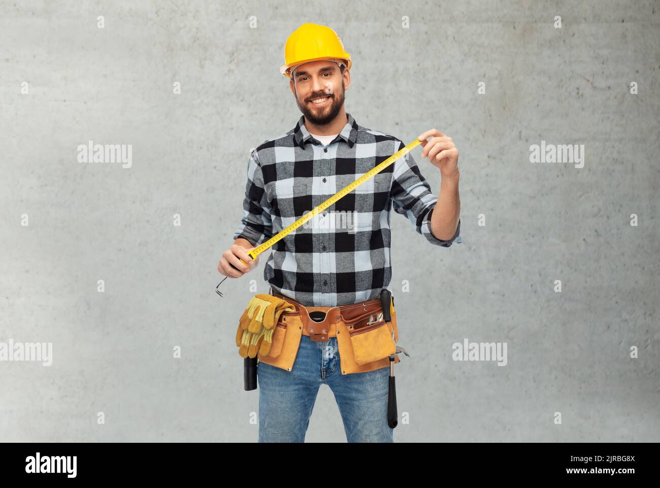 Builder in helmet measuring hi-res stock photography and images - Alamy