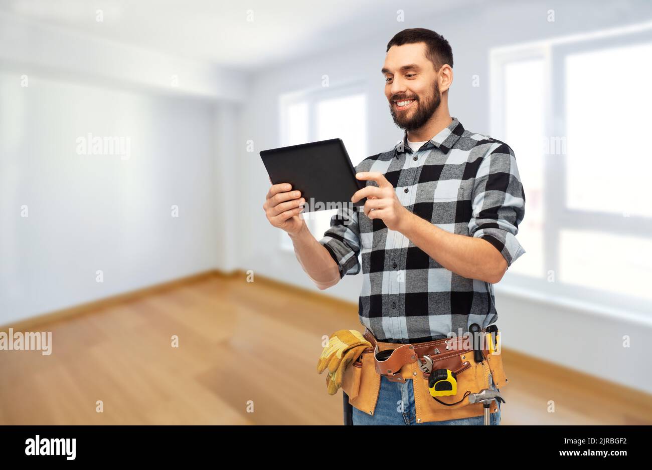 happy builder with tablet computer and tools Stock Photo - Alamy