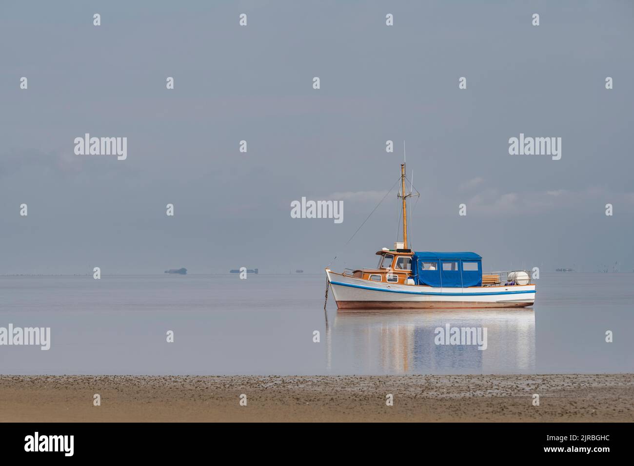 Germany, Schleswig-Holstein, Pellworm, Fishing boat at low tide Stock ...