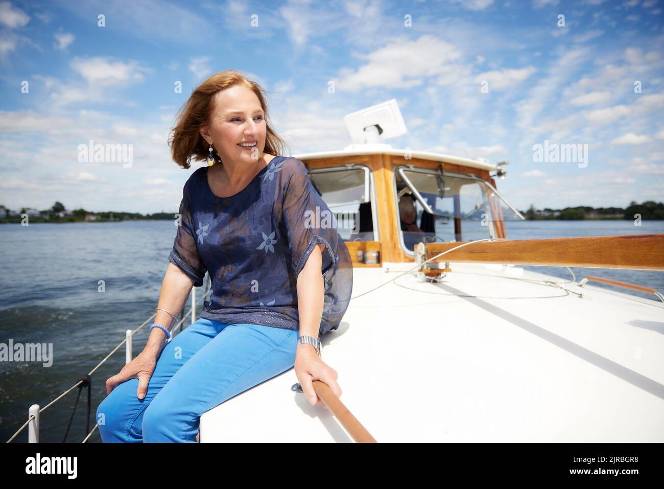 Happy senior woman sitting on boat deck at vacation Stock Photo - Alamy