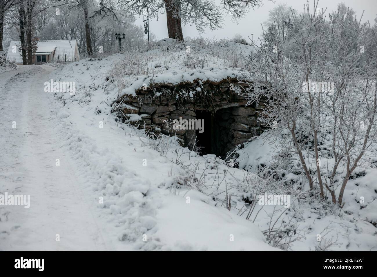 An old abandoned underground bunker covered in snow in the forest Stock ...