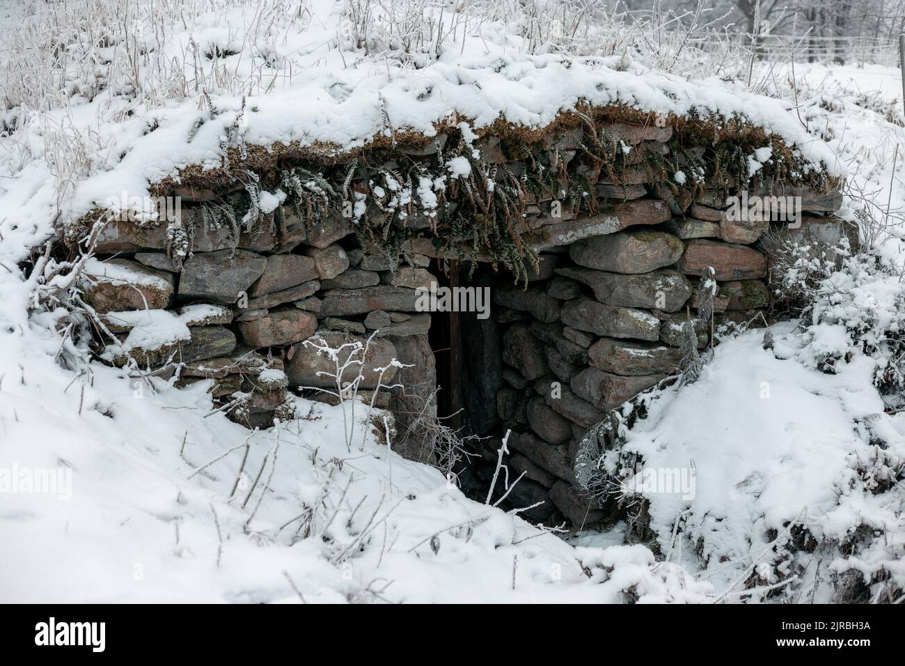 A closeup of an old abandoned underground bunker covered in snow Stock ...