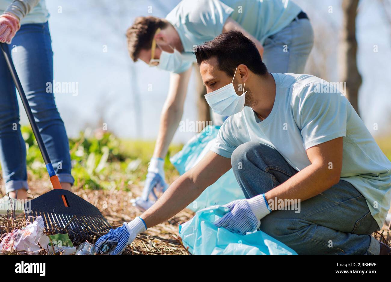 volunteers with garbage bags cleaning park area Stock Photo - Alamy