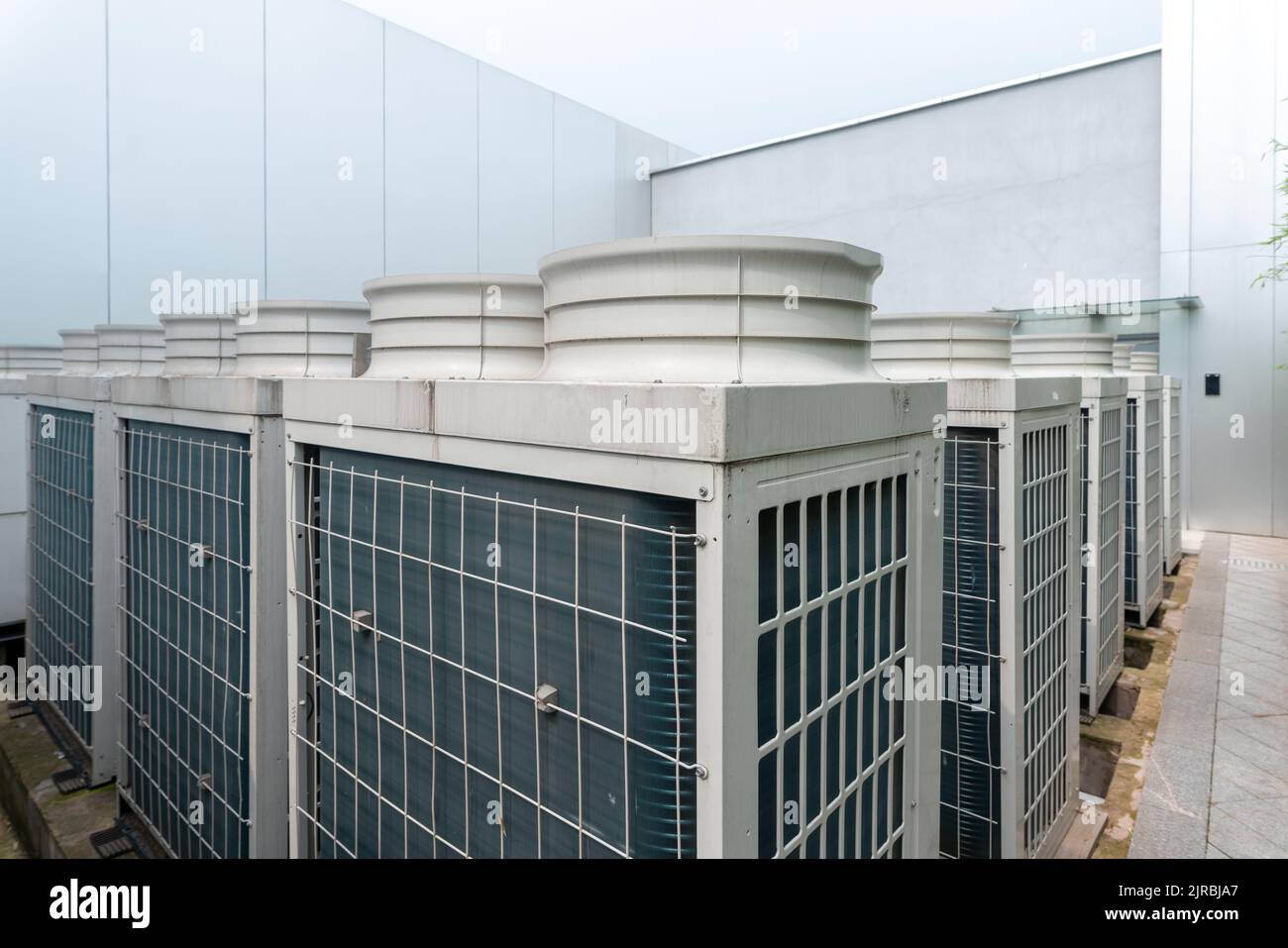 A large group of modern central air conditioners outside of the ...