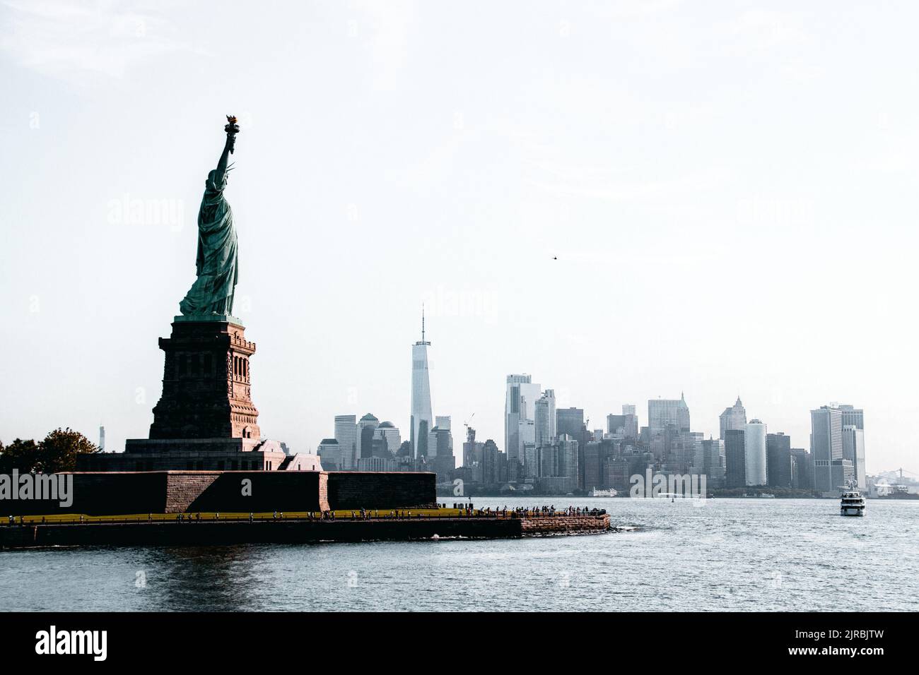 An aerial view of statue of Liberty surrounded by water in New York ...