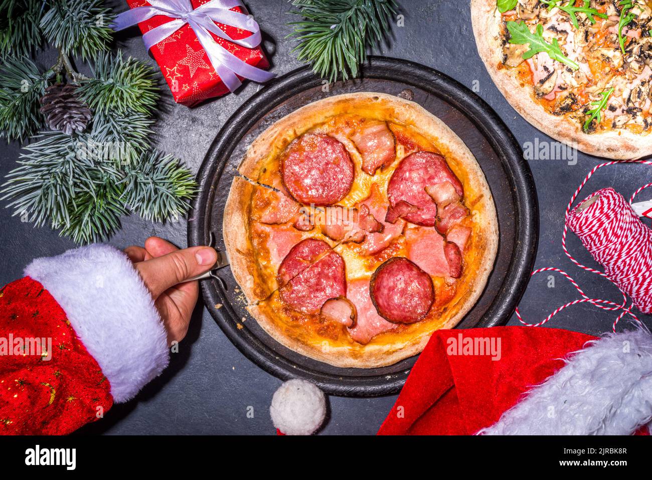 Christmas decorated background with pepperoni and mushrooms pizza,with ...