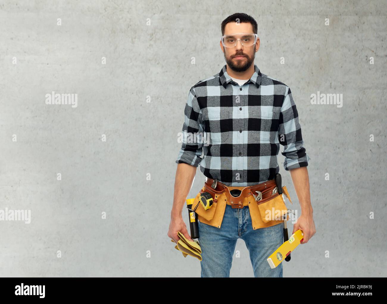 male worker or builder with tools and level Stock Photo - Alamy