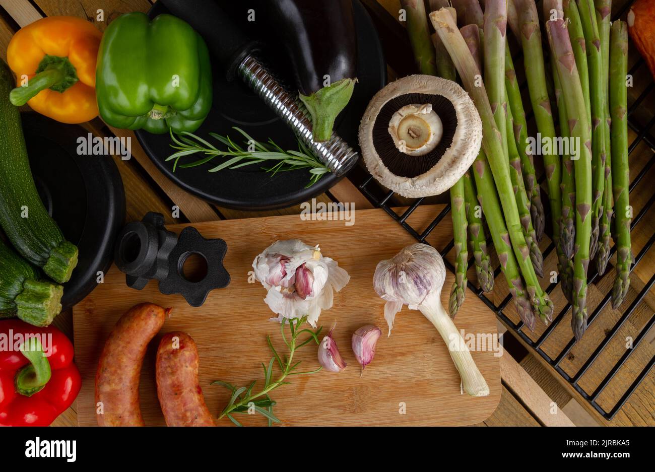 Heavy dumbbells barbell weight plates, vegetables and sausages for ...