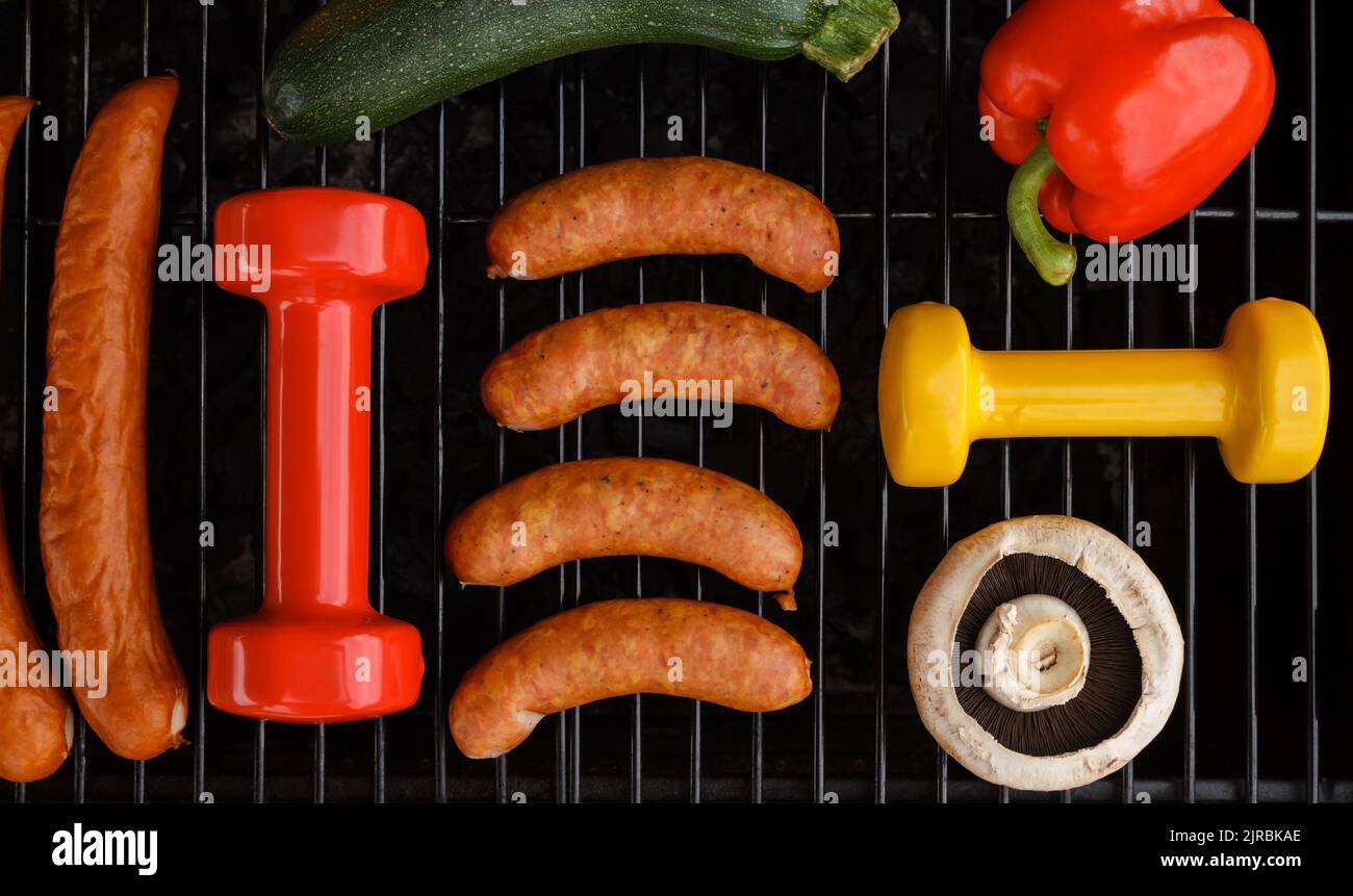 Dumbbells with vegetables, sausages on a grill. Fit barbecue party ...