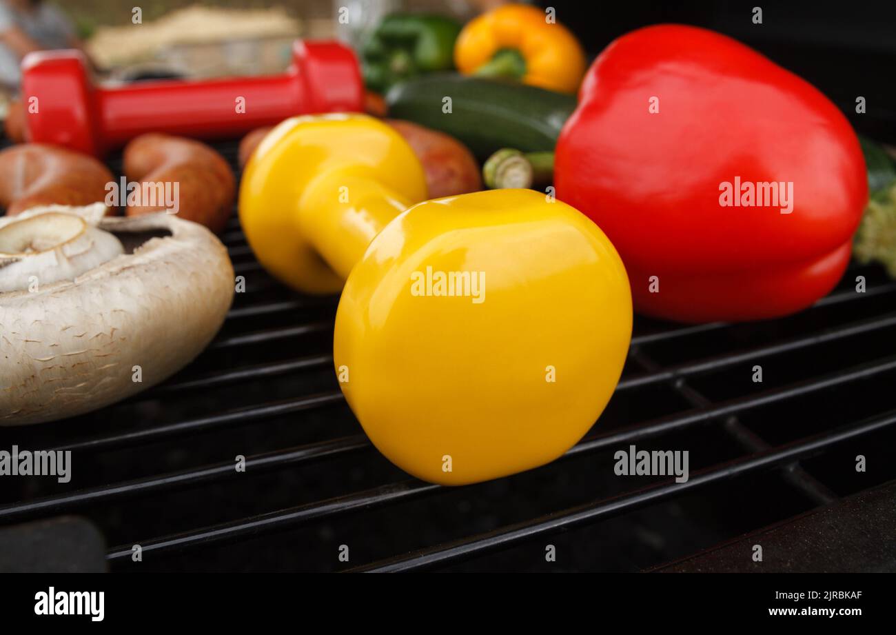 Dumbbells with vegetables, sausages on a grill. Fit barbecue party ...