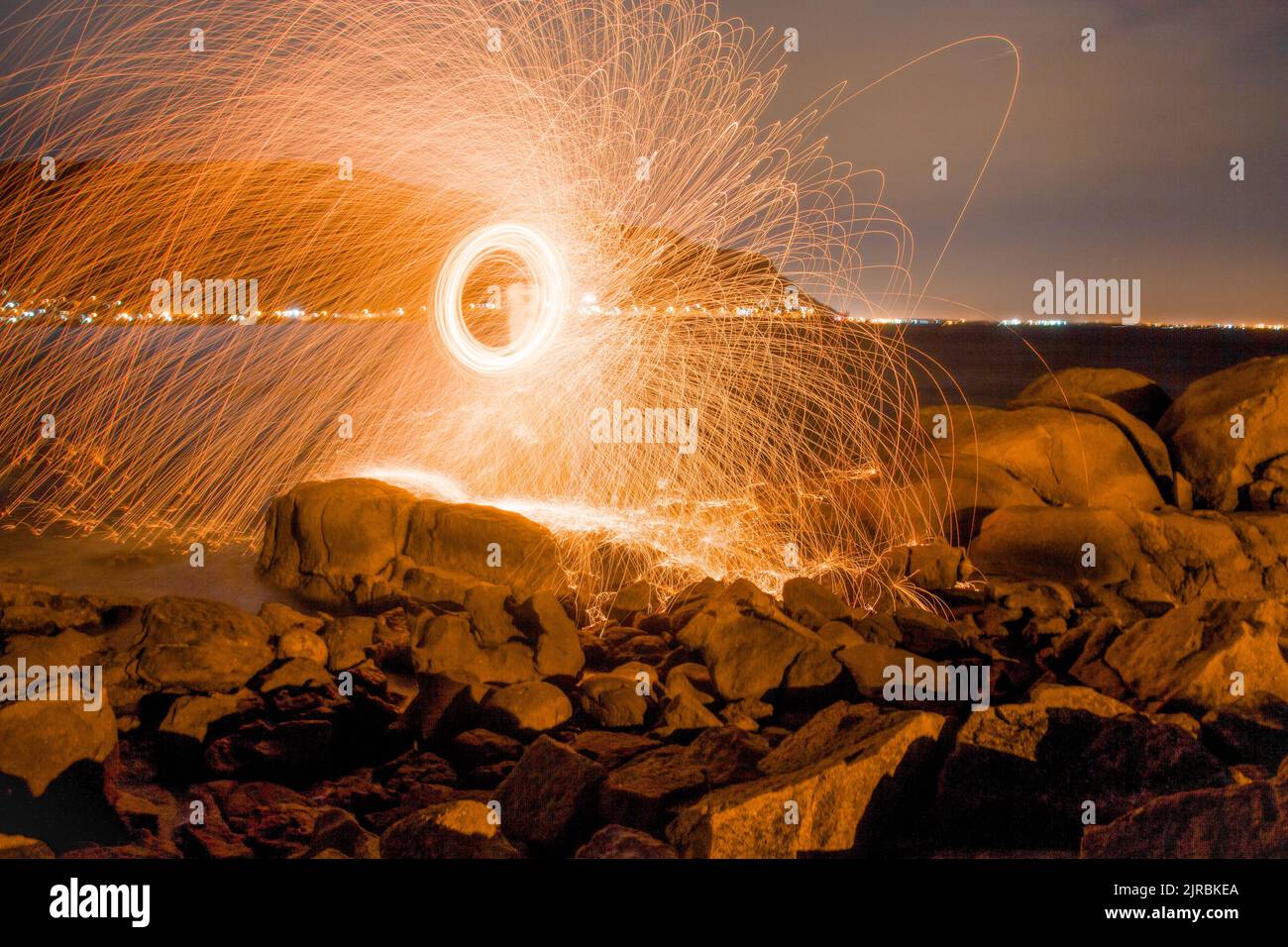 A view of circle fire sparks over rocks Stock Photo - Alamy