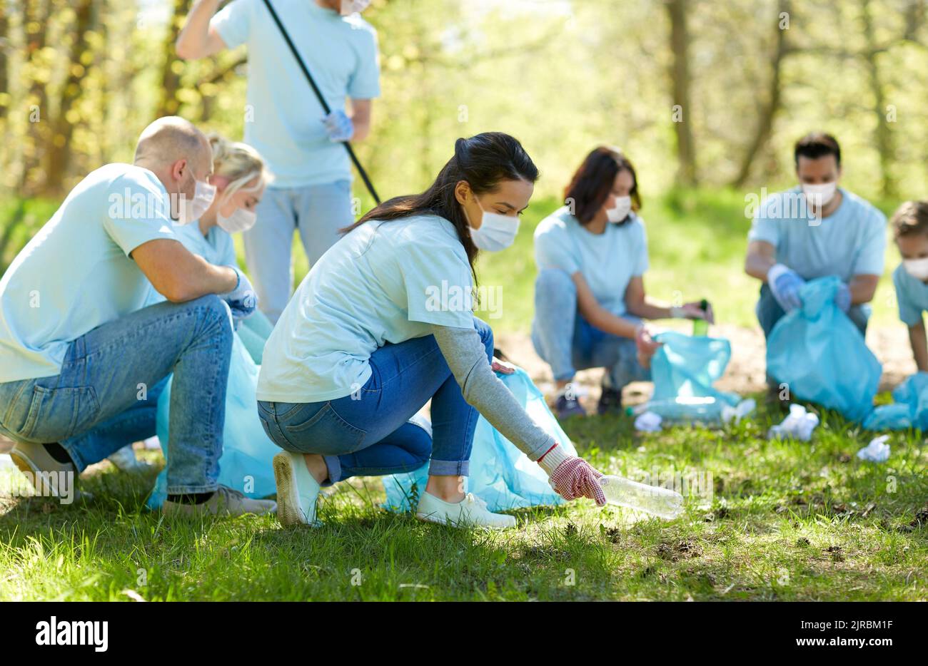 volunteers in masks cleaning park from garbage Stock Photo - Alamy