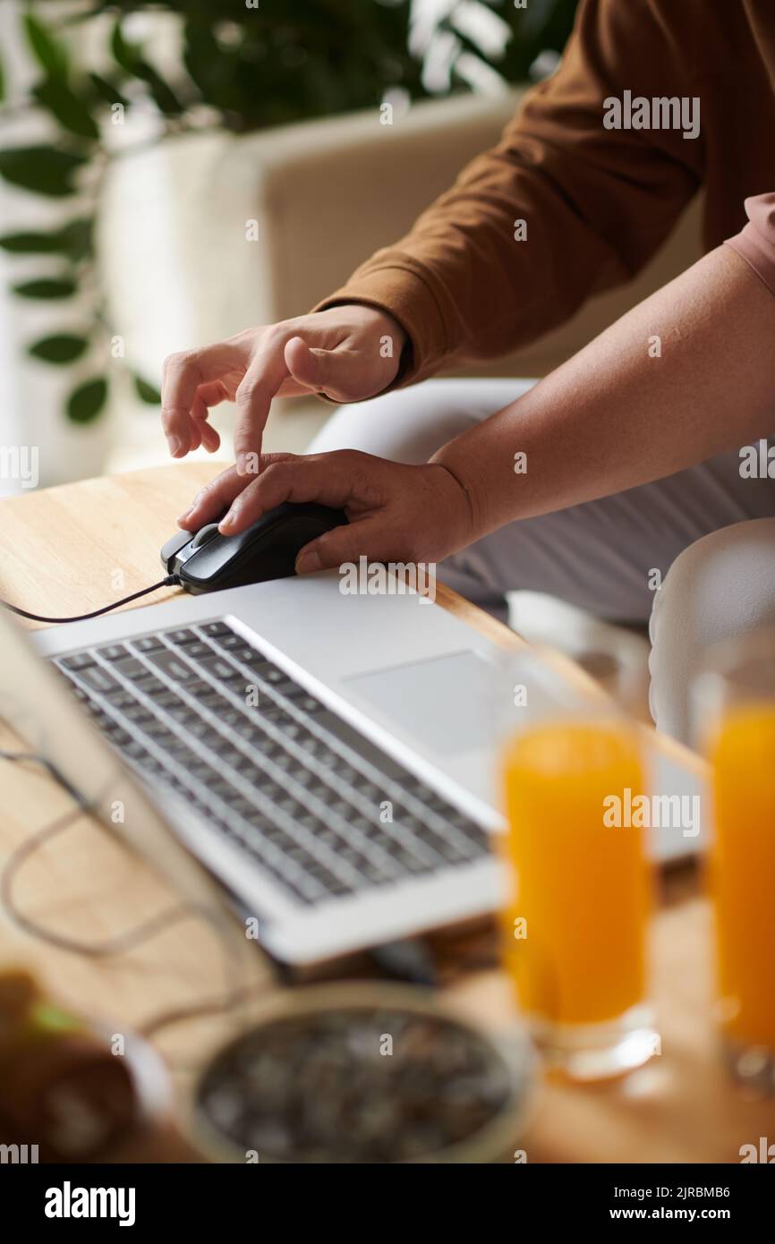 Closeup image of young man explaining grandmother how to use computer ...