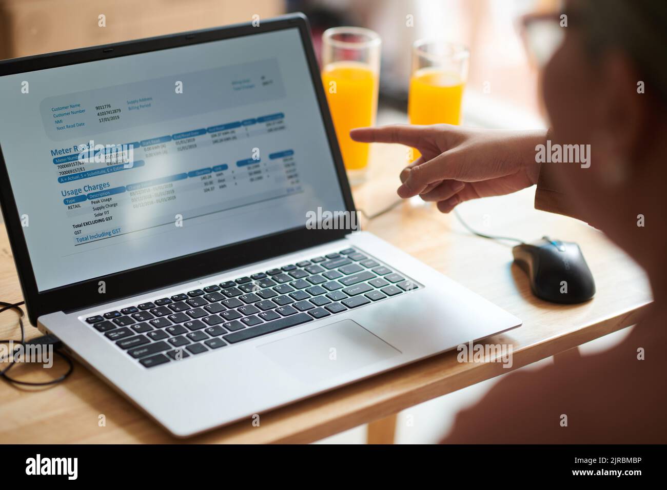 Grandson explaining senior woman how to pay utility bills online Stock ...