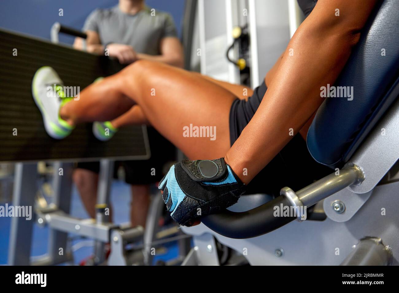 woman flexing muscles on leg press machine in gym Stock Photo - Alamy