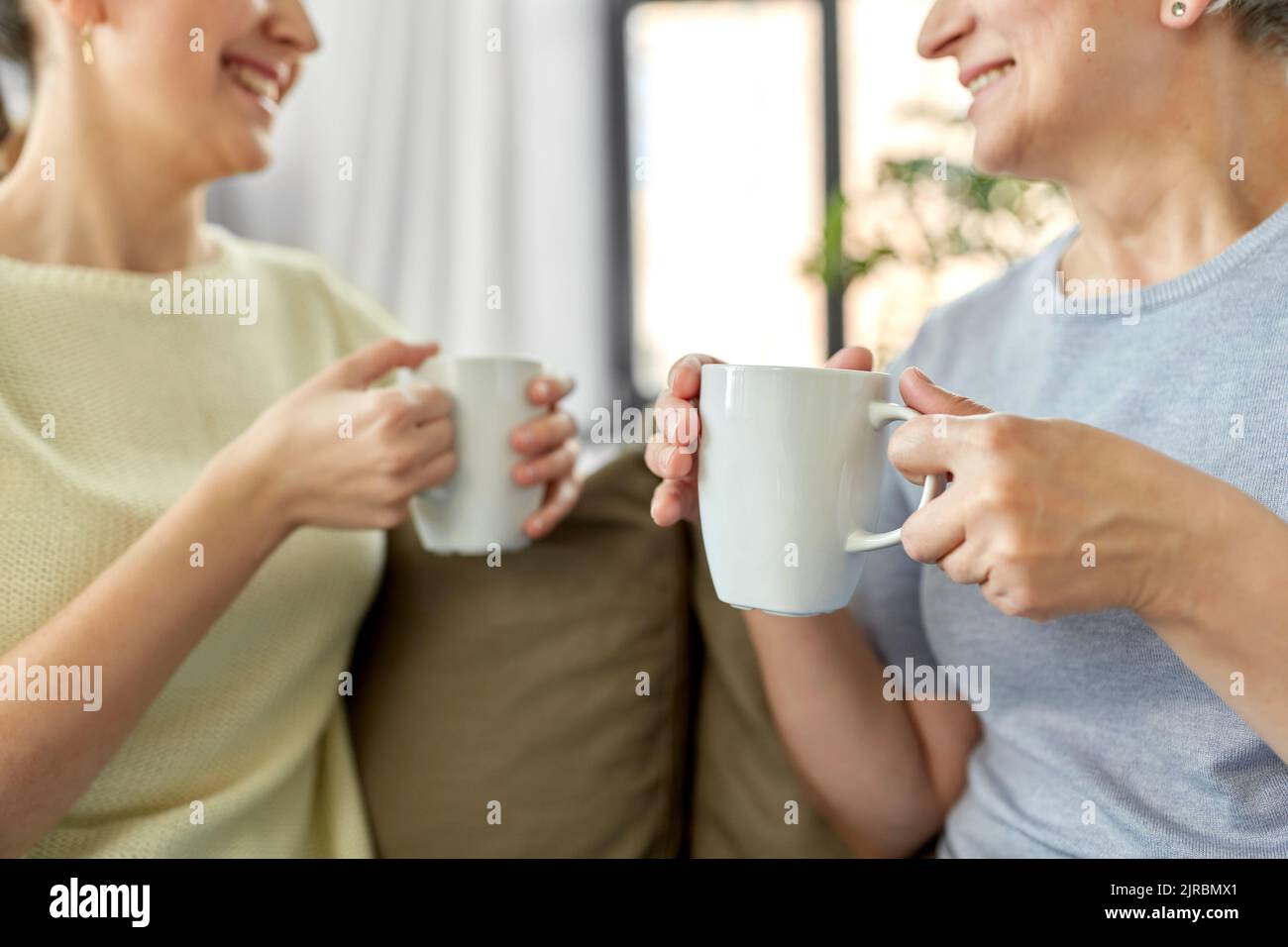 senior mother and adult daughter drinking coffee Stock Photo - Alamy