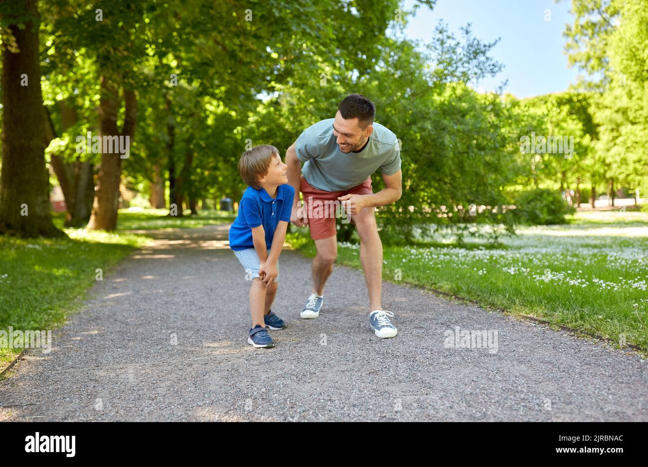 happy father and son compete in running at park Stock Photo - Alamy