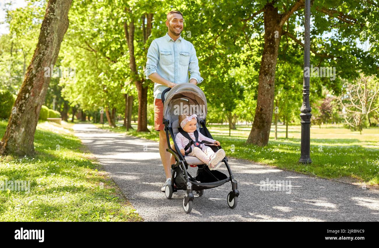 happy father with child in stroller at summer park Stock Photo - Alamy