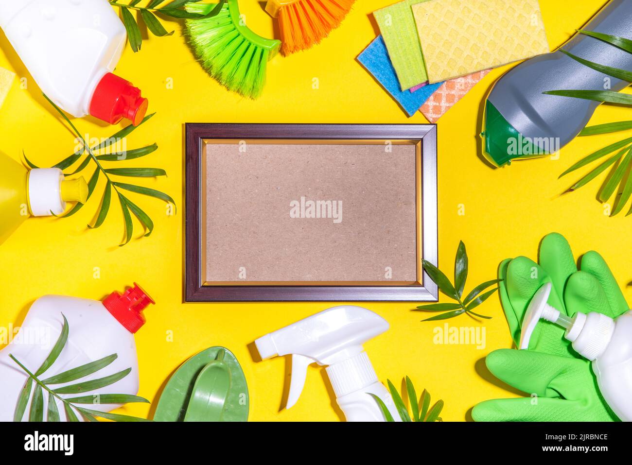 Summer cleaning concept. Plastic basket with different detergents and ...