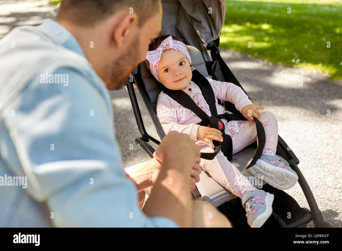 happy father with child in stroller at summer park Stock Photo - Alamy