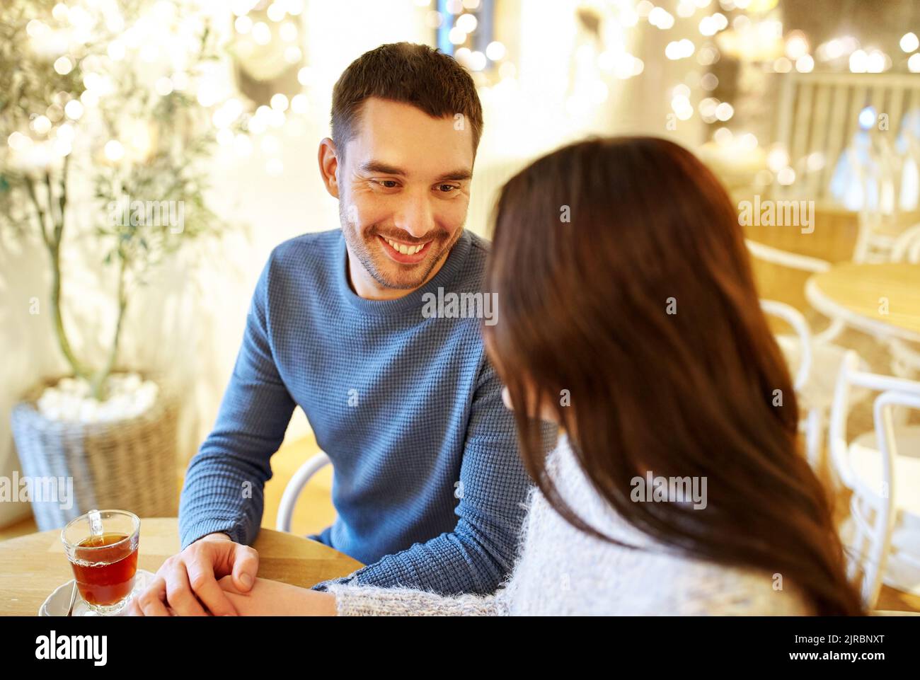 happy couple drinking tea at cafe Stock Photo - Alamy