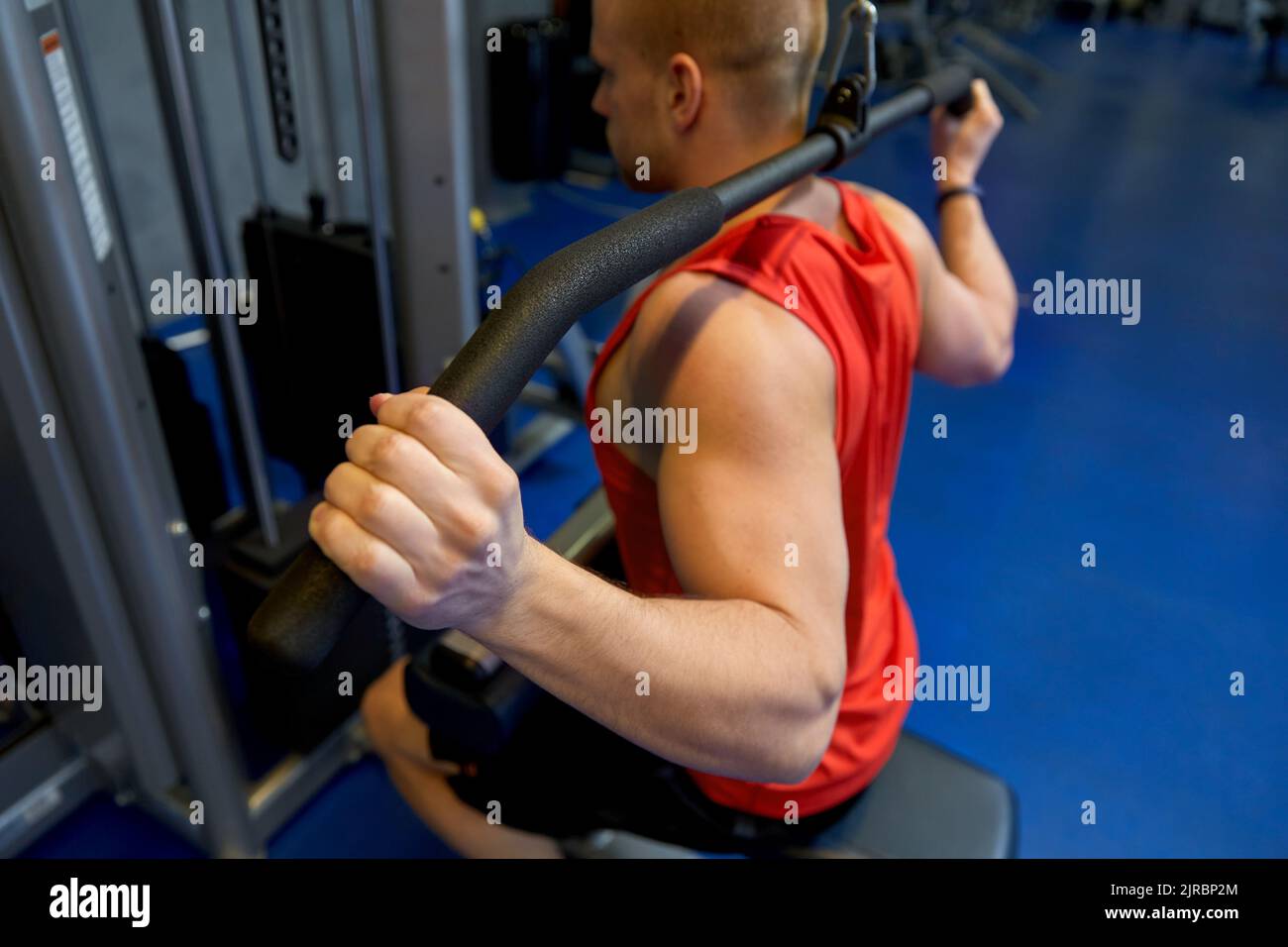 close up of man exercising on cable machine in gym Stock Photo - Alamy