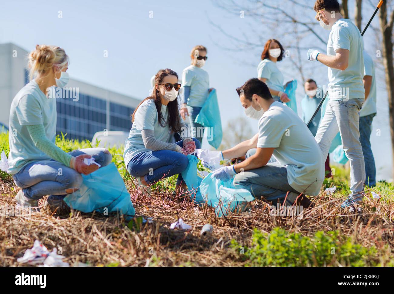 volunteers with garbage bags cleaning park area Stock Photo - Alamy