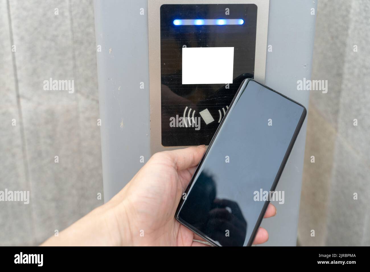 A hand holding a mobile phone to connect and scan the personal ...