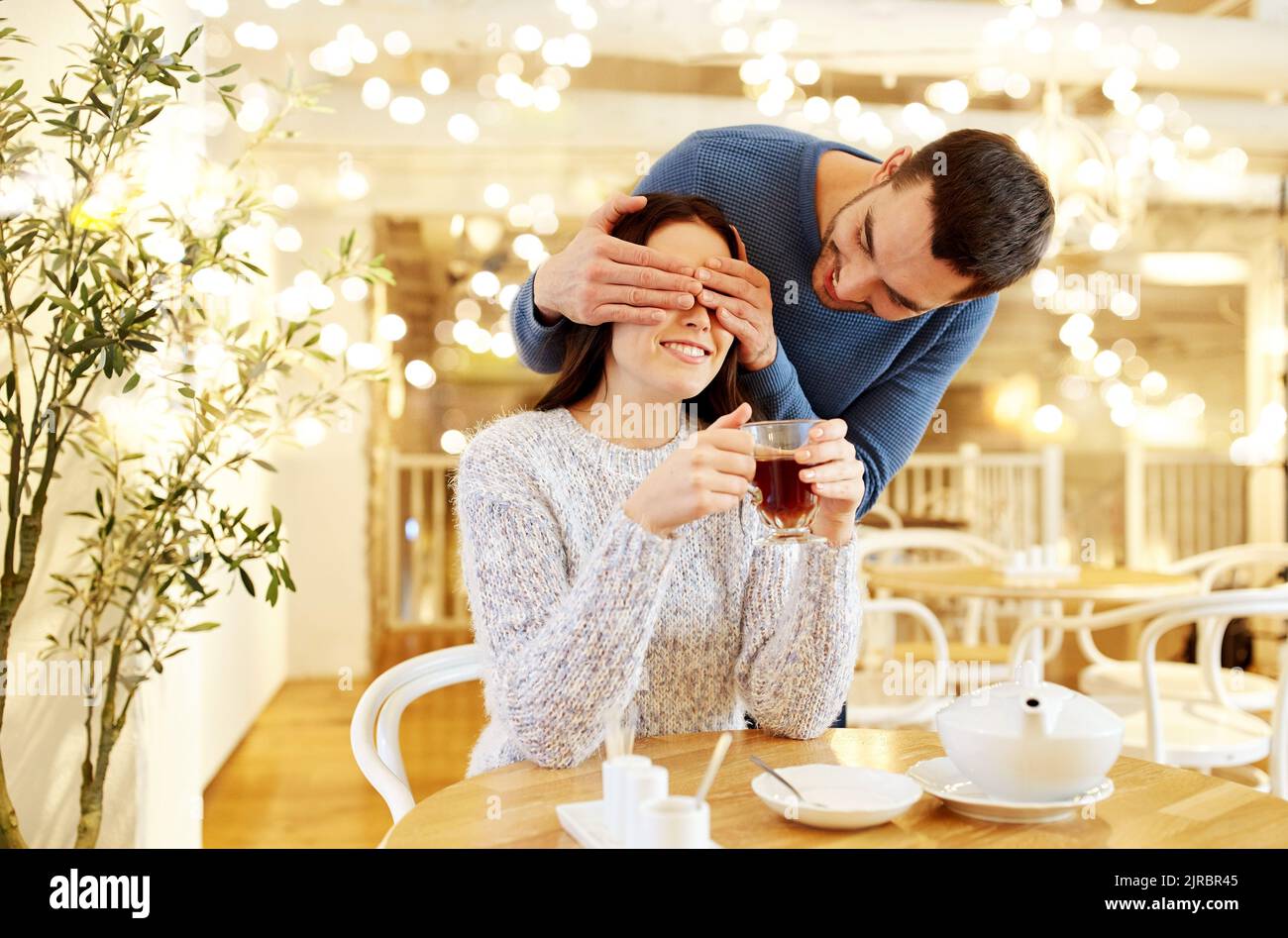 happy couple drinking tea at cafe Stock Photo - Alamy