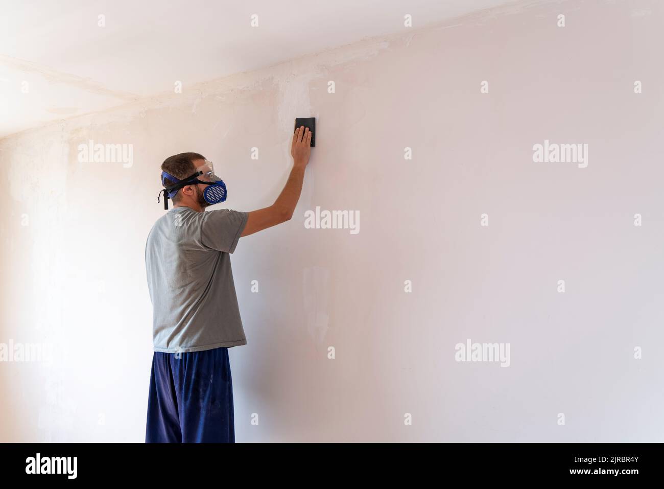 Handyman smoothing wall sandpaper tool hi-res stock photography and ...