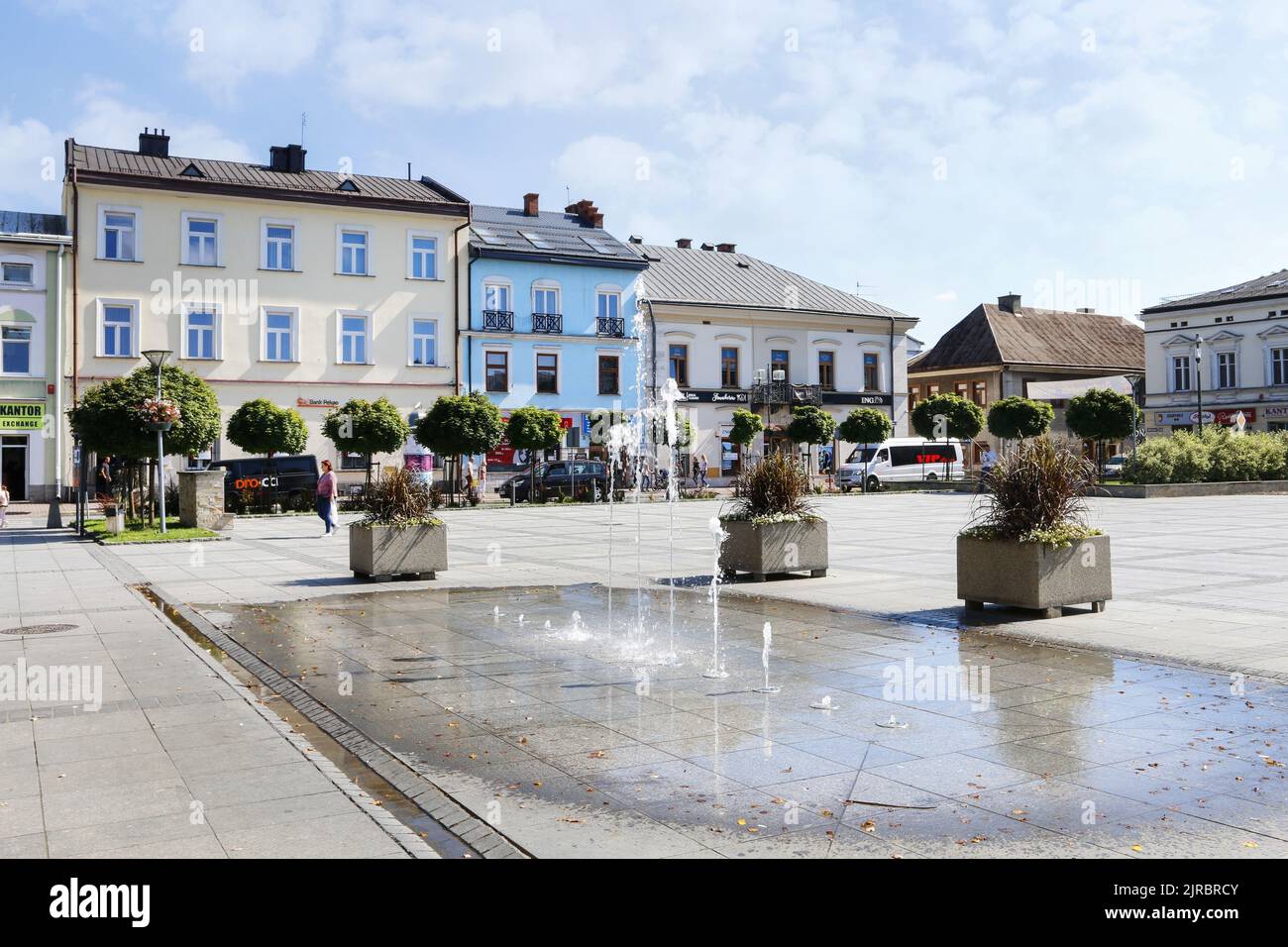 Modern fountain and colorful tenements by the main market square in ...