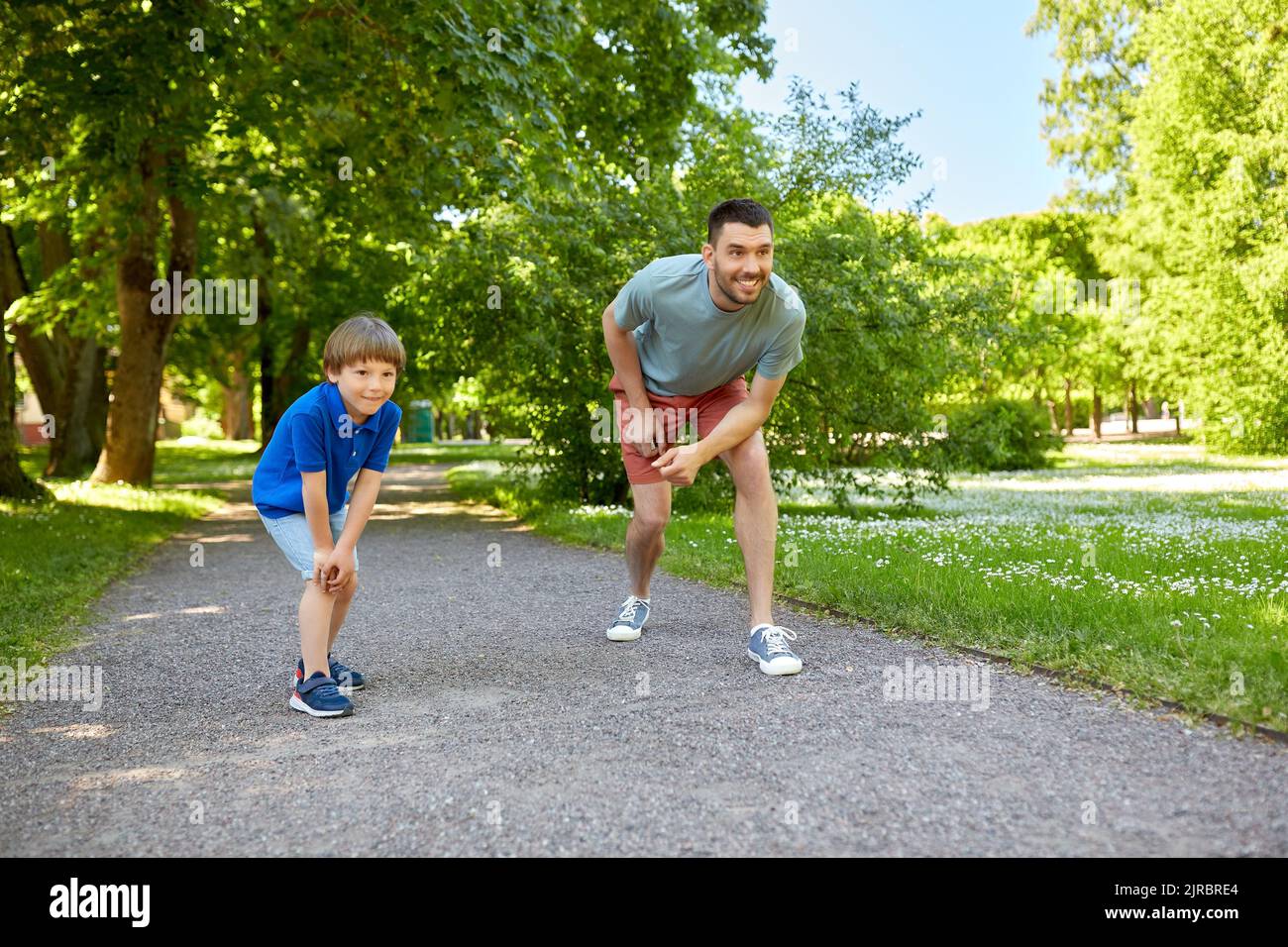 happy father and son compete in running at park Stock Photo - Alamy