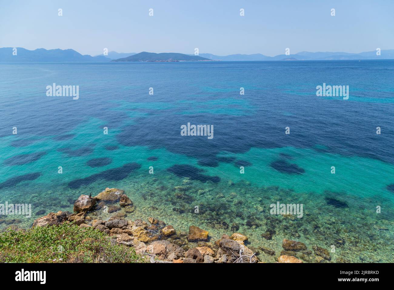 The coast of Aegina island with clear and blue waters of Mediterranean ...