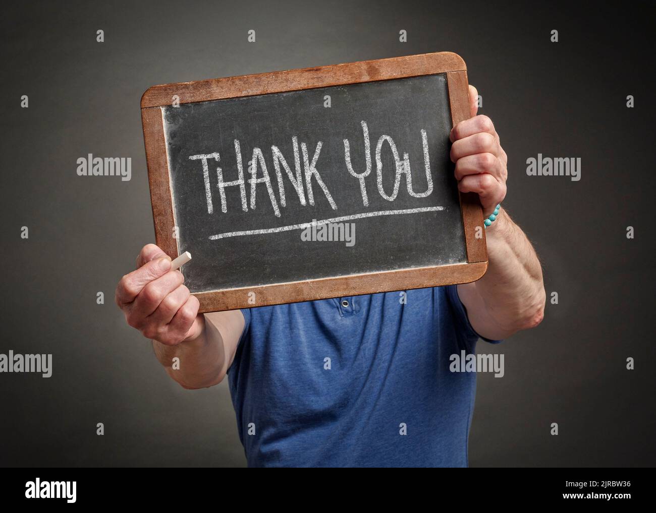 thank you - white chalk writing on a slate blackboard held by a men ...