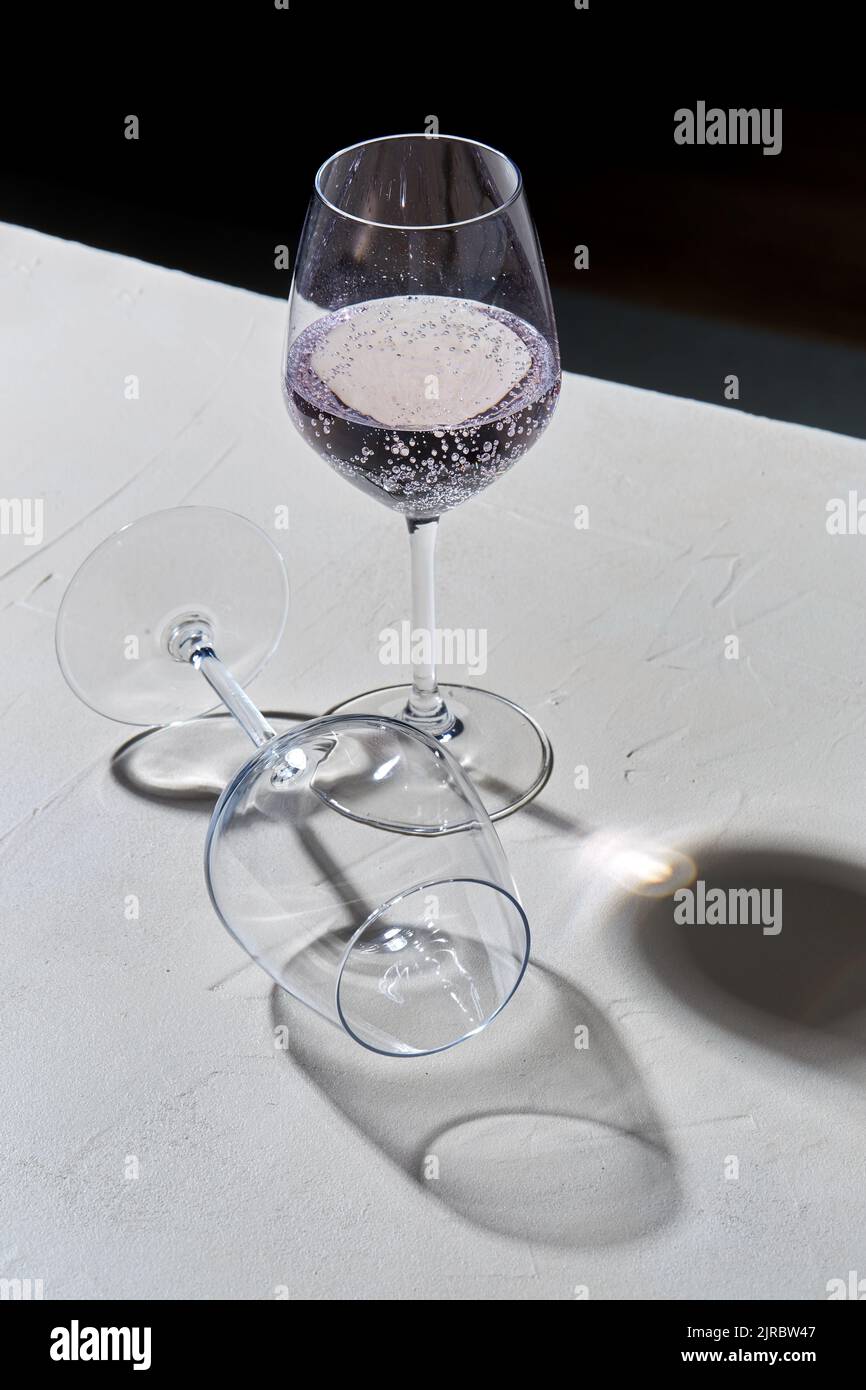 wine glasses dropping shadows on white surface Stock Photo - Alamy