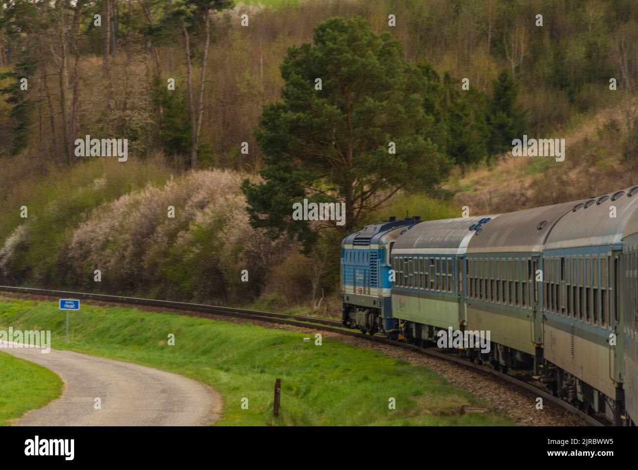 Blue diesel locomotive and blue passenger coach near Jihlava town in ...