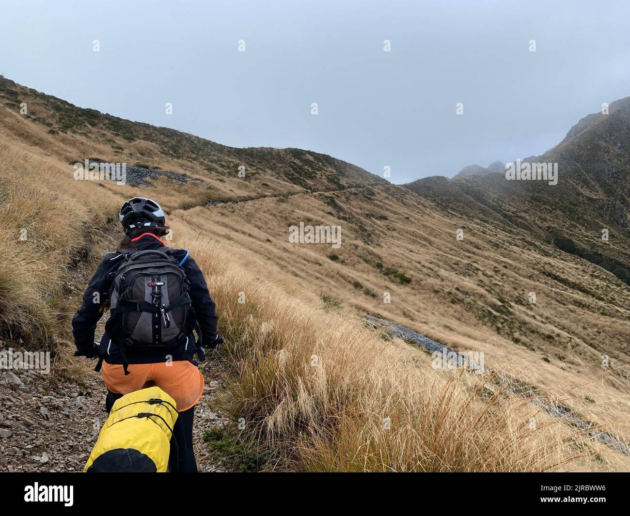 A woman riding a mountain bike along a mountain ridge Stock Photo - Alamy