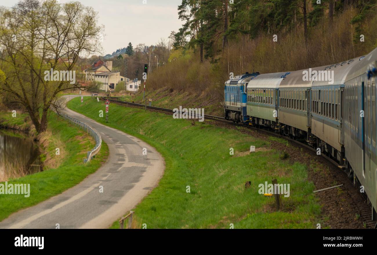 Blue diesel locomotive and blue passenger coach near Jihlava town in ...