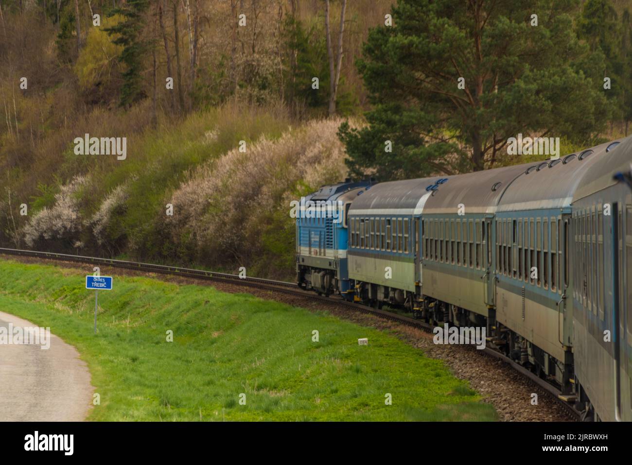 Blue diesel locomotive and blue passenger coach near Jihlava town in ...