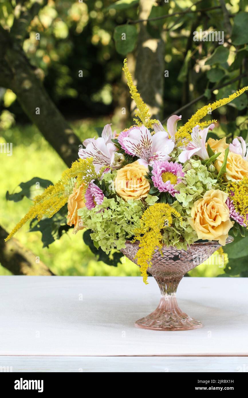 Modern table's centerpiece for summer wedding. A lot of greenery being ...