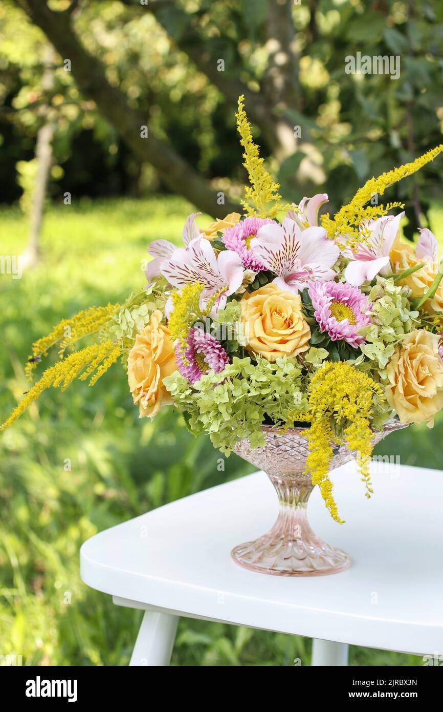 Modern table's centerpiece for summer wedding. A lot of greenery being ...