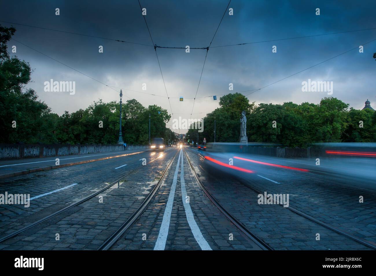 Dark rainy clouds looming over speedy city traffic before a ...