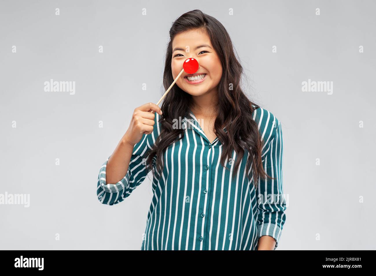 happy asian woman with red clown nose Stock Photo - Alamy