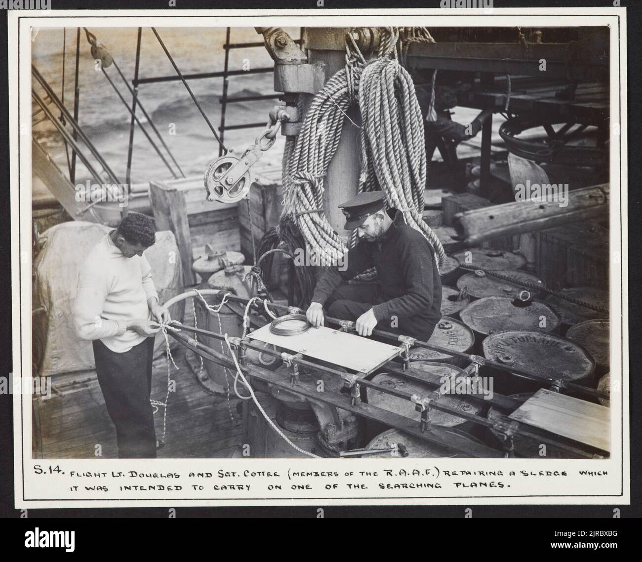 Flight Lt. Douglas and Sgt Cottee (members of the R.A.A.F) repairing a ...