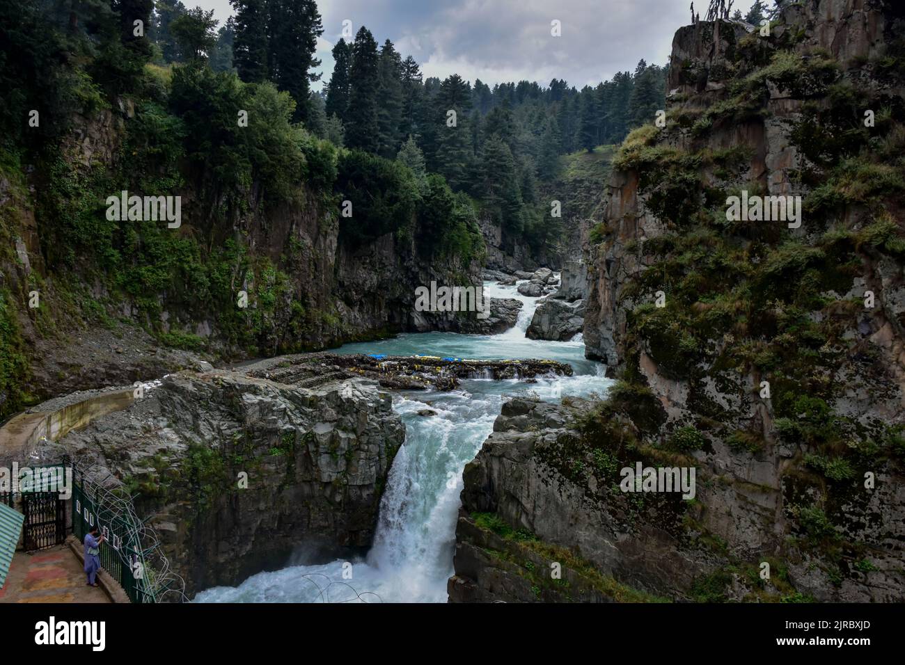 A man takes pictures of the Aharbal waterfall, also known as "Niagara ...