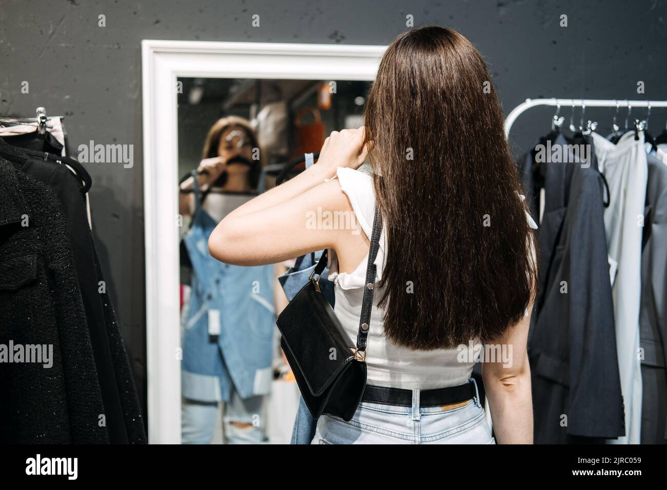 Second hand. Sustainable fashion. Young Latina woman buying used ...