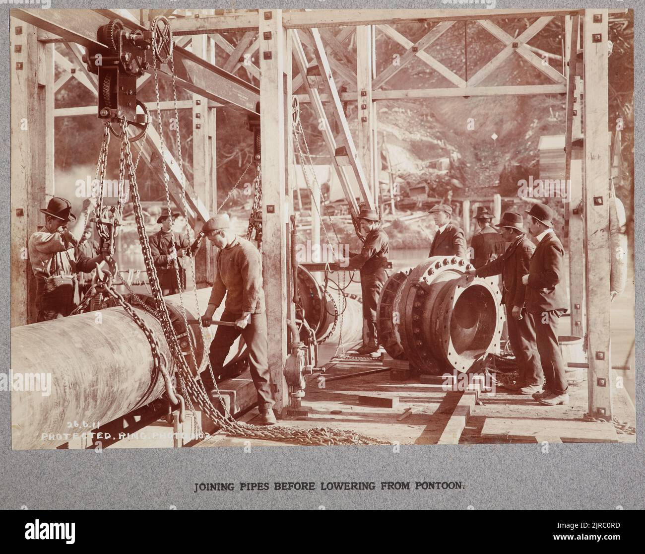 Joining pipes before lowering from pontoon from the album hi-res stock ...