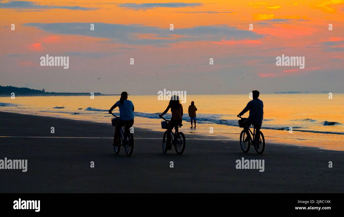 Family riding bikes on the beach on Hilton Head SC , sunrise Stock ...
